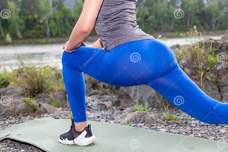Close Up On A Tight Booty Of Pretty Woman While She Is Doing Stretching