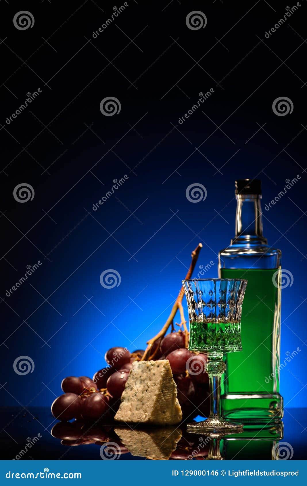 Close-up Shot of Absinthe with Grapes and Dorblu Cheese on Mirror ...