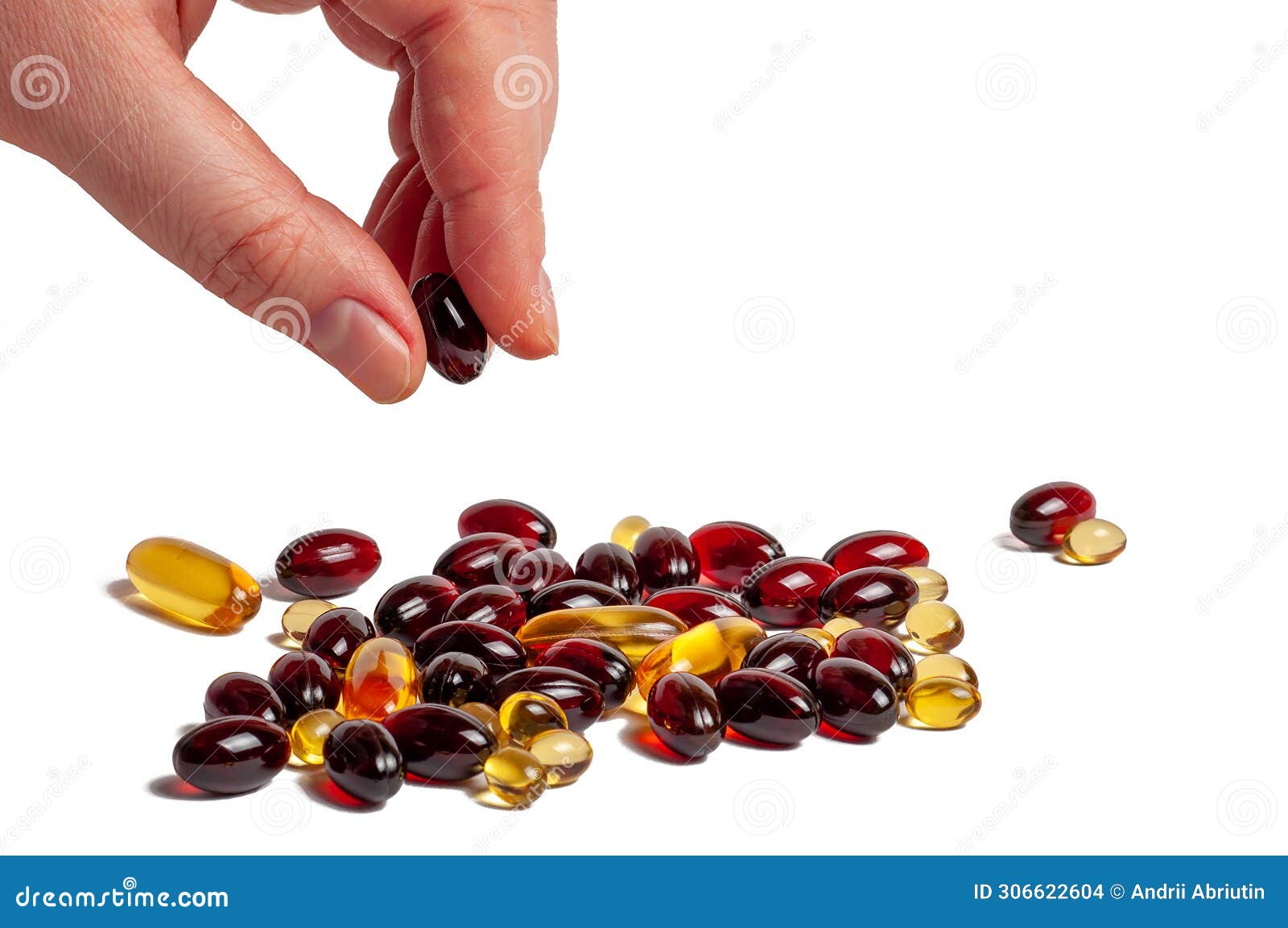 A Hand Picking Up a Supplement from a Pile of Various Capsules. Stock ...