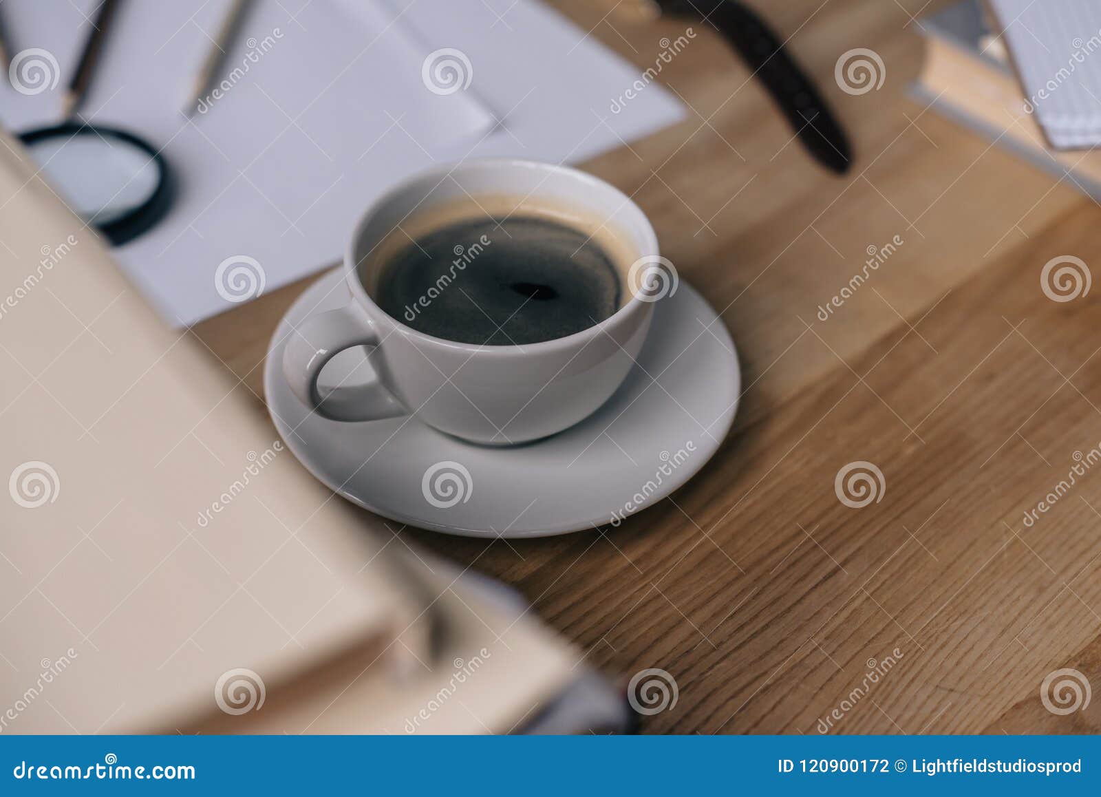 Close-up Shot of Cup of Coffee on Work Desk with Stack Stock Photo ...