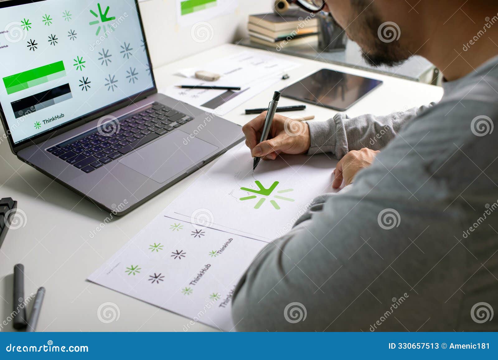 Graphic Designer Making Notes on Logo Designs, Designing Logos, and ...