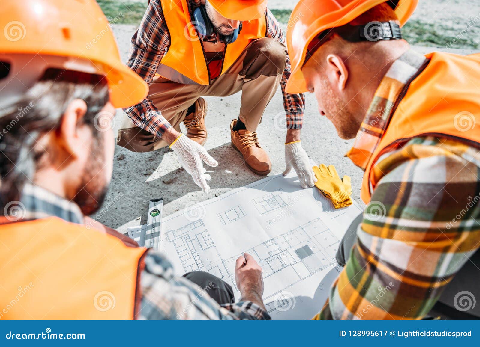 Close-up Shot of Group of Builders in Hard Hats Having Conversation ...
