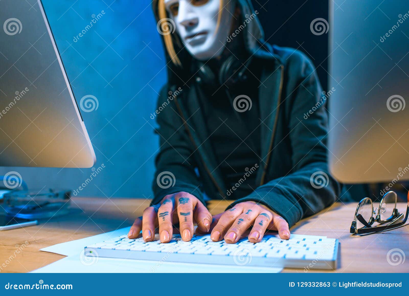 Close-up Shot of Masked Female Hacker with Tattoos on Hands Stock Image ...