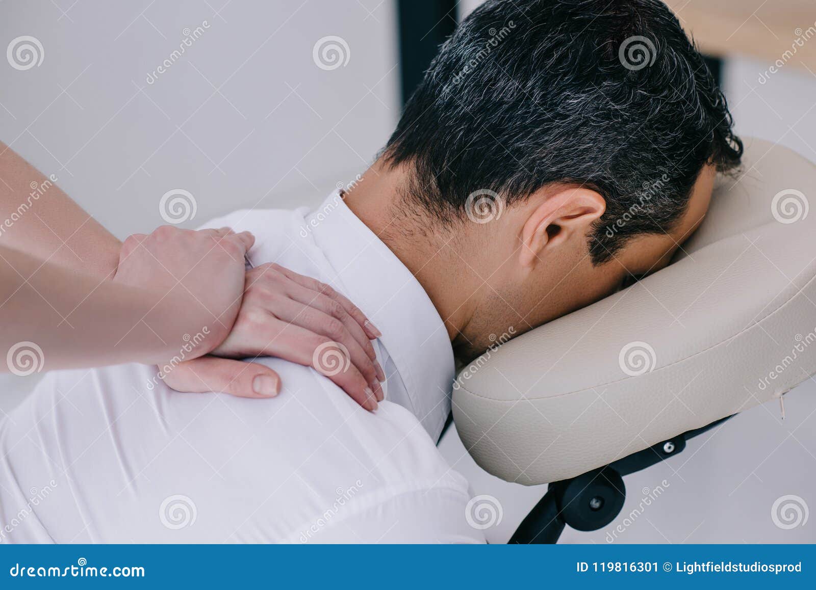 Close Up Shot Of Professional Masseuse Doing Seated Massage Stock Image