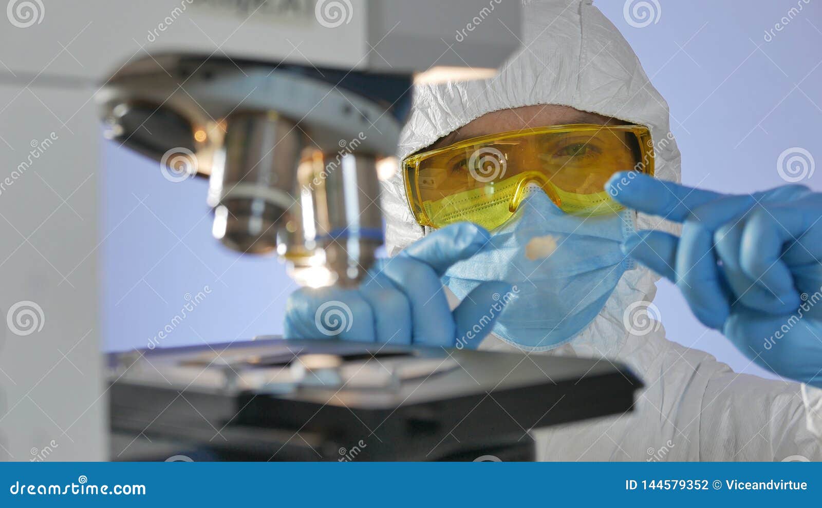 Close-up Shot of a Scientist Looking at a Glass Slide with Bacteria ...