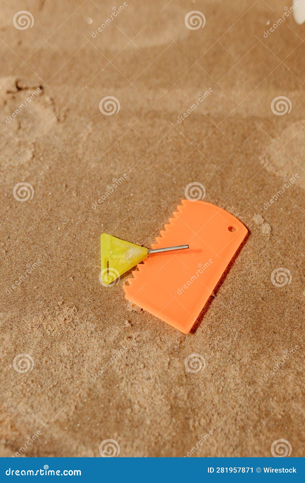 Close-up Shot of a Surfboard Fin Key Lying on a Sandy Beach Stock Image ...