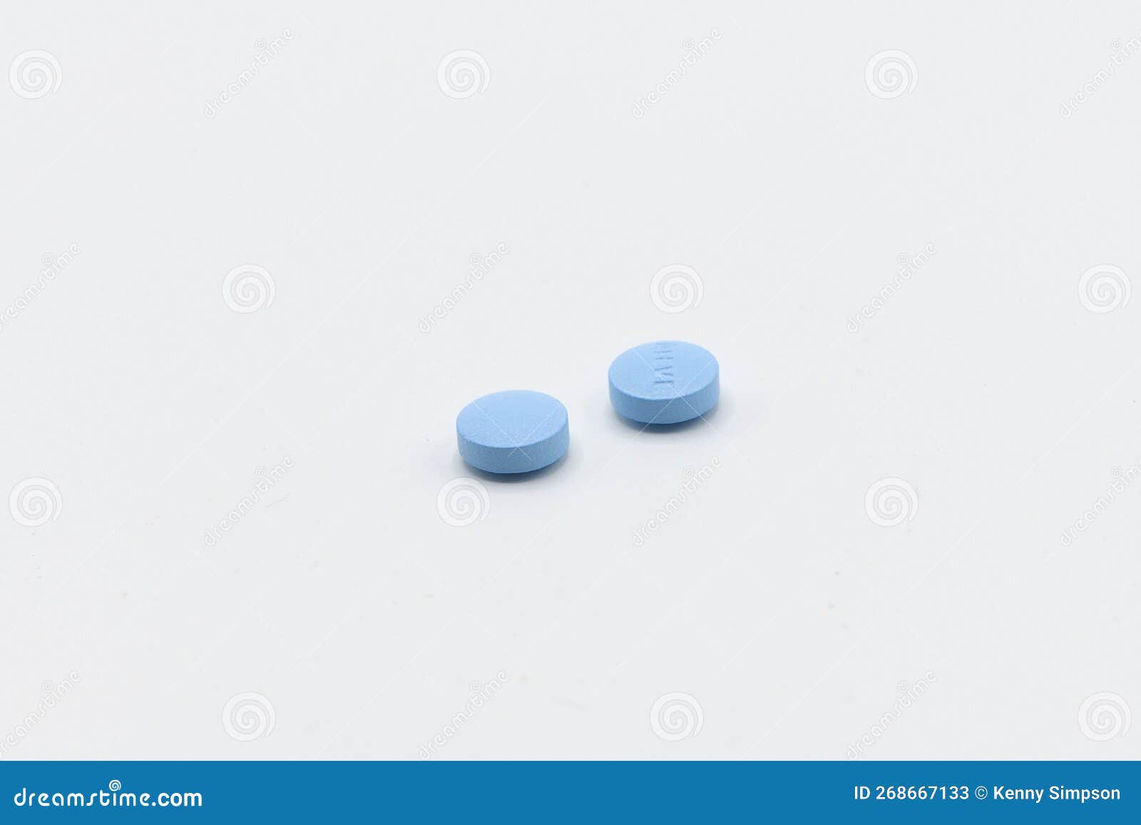 Two Blue Pills on a White Background Stock Image - Image of close ...