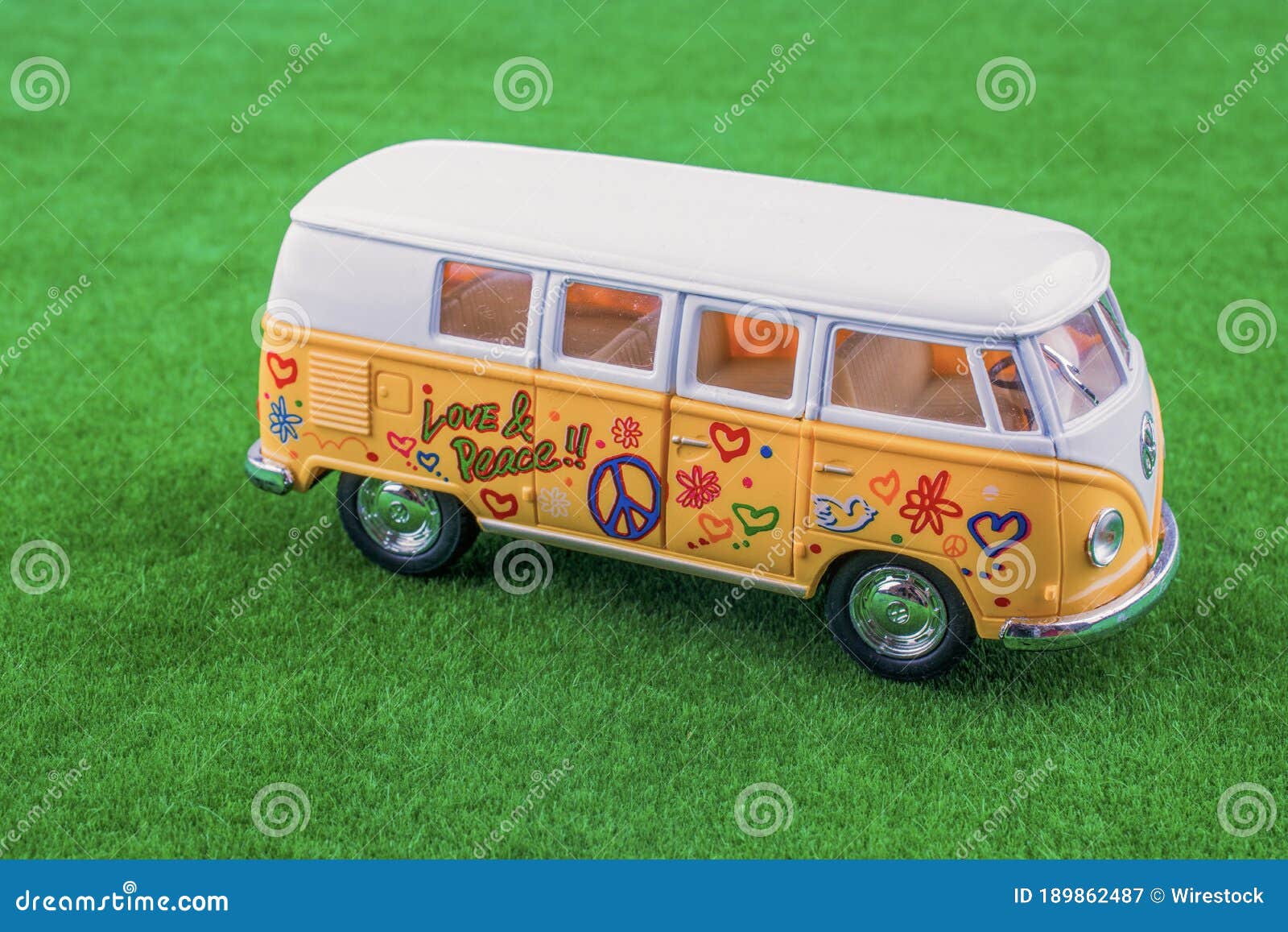Close Up Shot of a Yellow Mini Bus with Artistic Texts on an Artificial ...