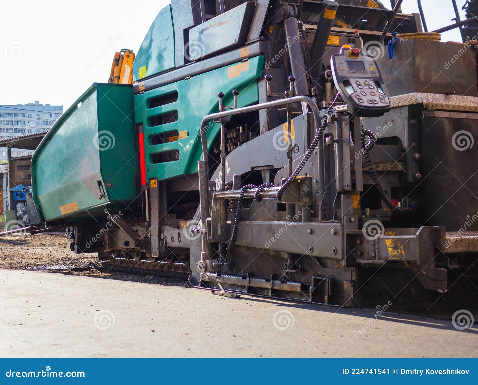 Close-up Side Back View of an Road Paver in the Process of Paving ...