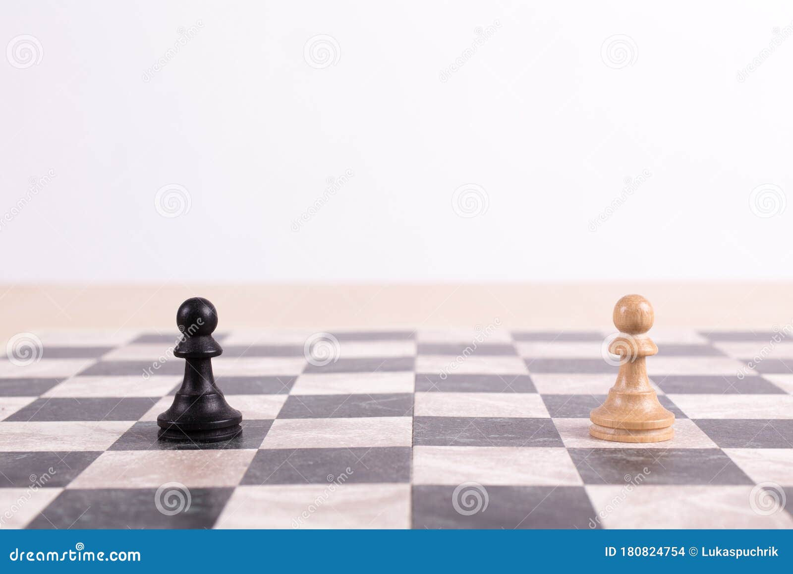 Close Up Side View of Chess Board with Black Pawn Facing White Pawn ...