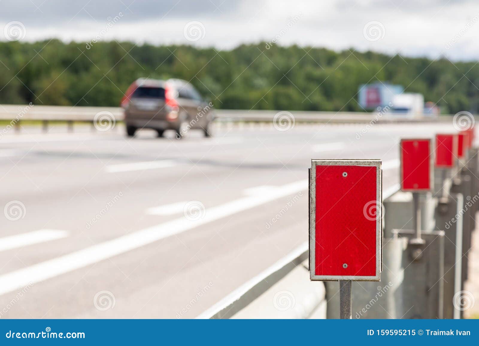 Close-up of Signposts with Red Light-reflecting Elements Along Highway ...