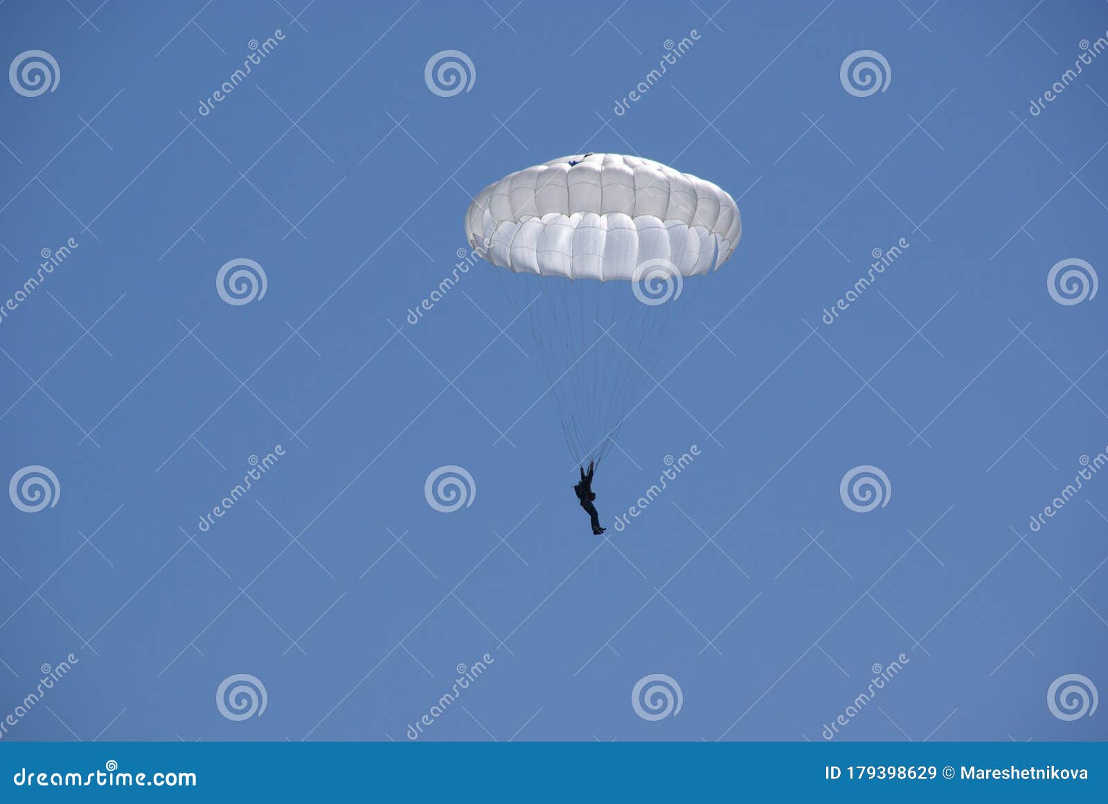Close-up of a Skydiver on a White Parachute in a Blue Sky Stock Image ...