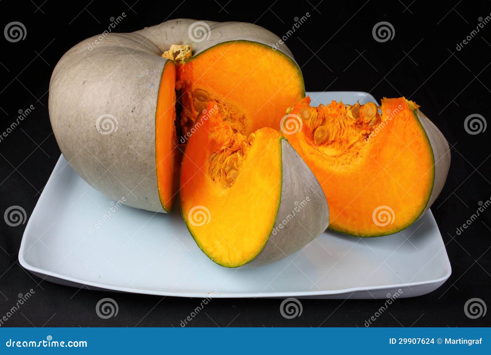 Slices of a Blue Pumpkin on Ceramic Plate by Black Background Stock ...