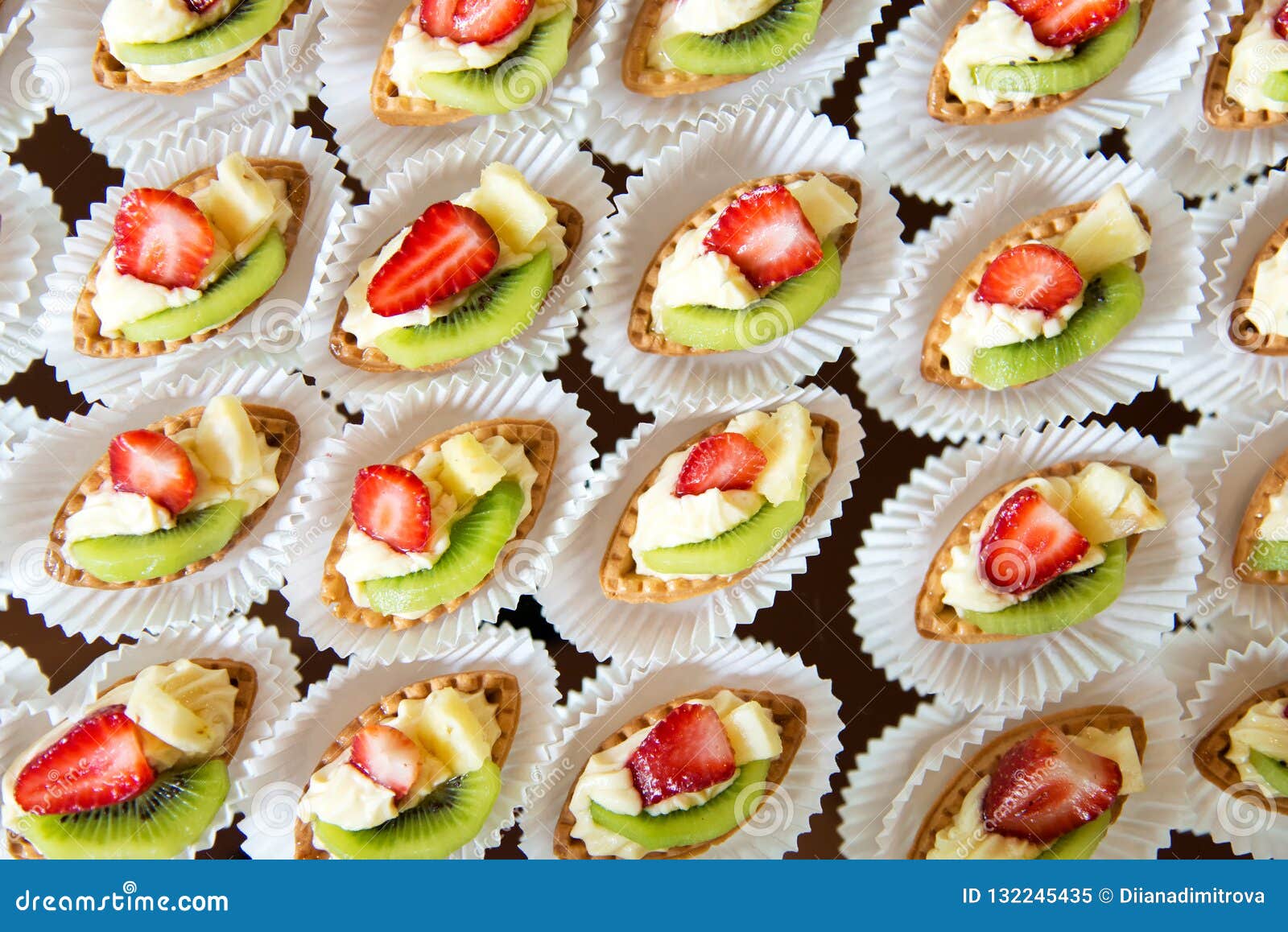 Close Up of Small Sweet Canapes Arranged on a Mirror Plate Over Light ...
