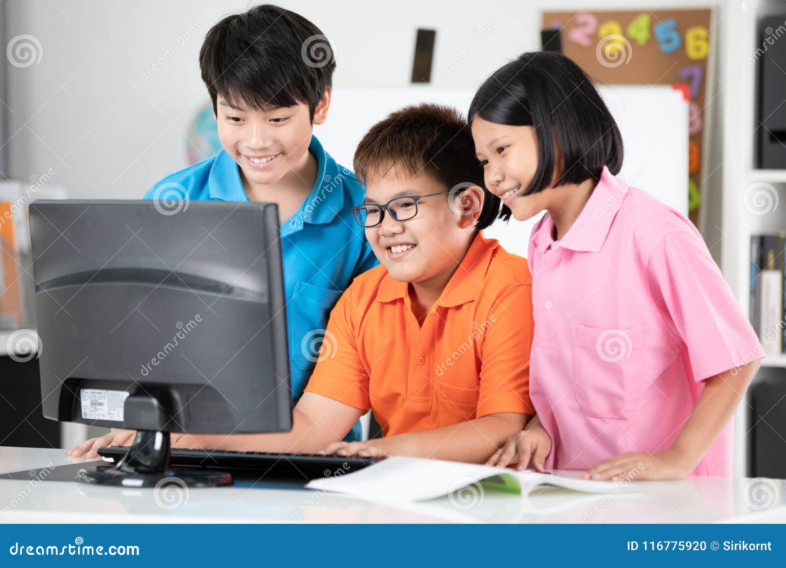 Close Up of Smiling Asian Pupils Using a Desktop Computer. Stock Photo ...