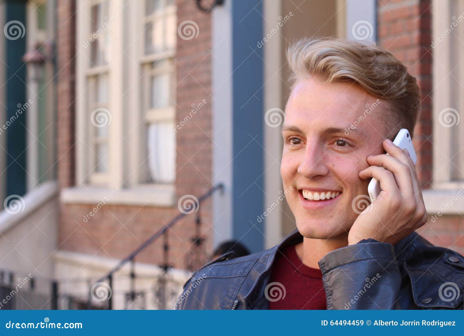 Close Up Smiling Attractive Young Guy Talking To Someone Using Mobile ...