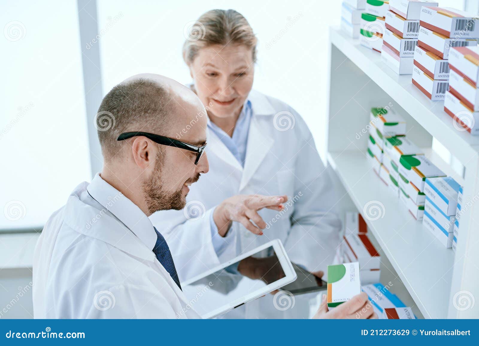 Smiling Pharmacists Discussing a New Batch of Medicines . Stock Image ...