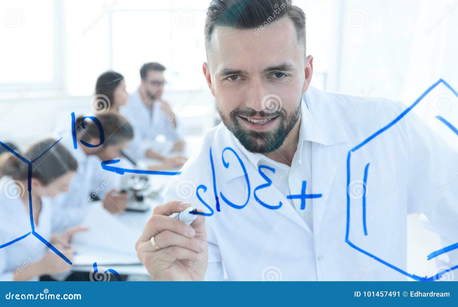 Close Up of a Smiling Scientist Writes a Formula on the Blackboard ...