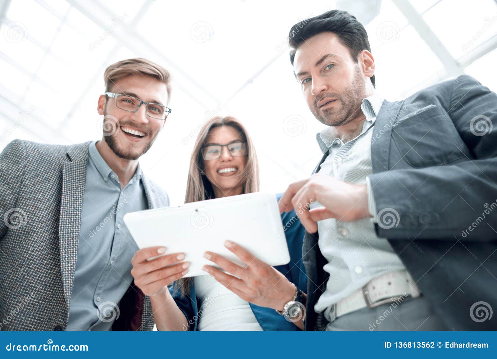 Close Up.smiling Staff Looking at the Digital Tablet Stock Photo ...