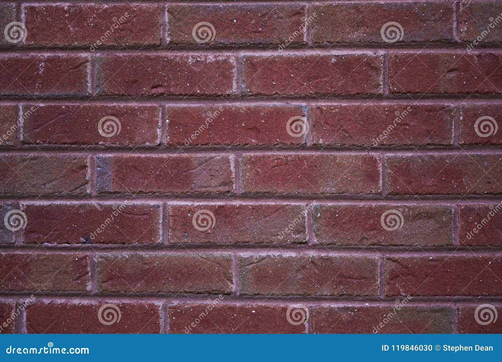A Close-up of a Solid Red Brick Wall Stock Photo - Image of bush ...