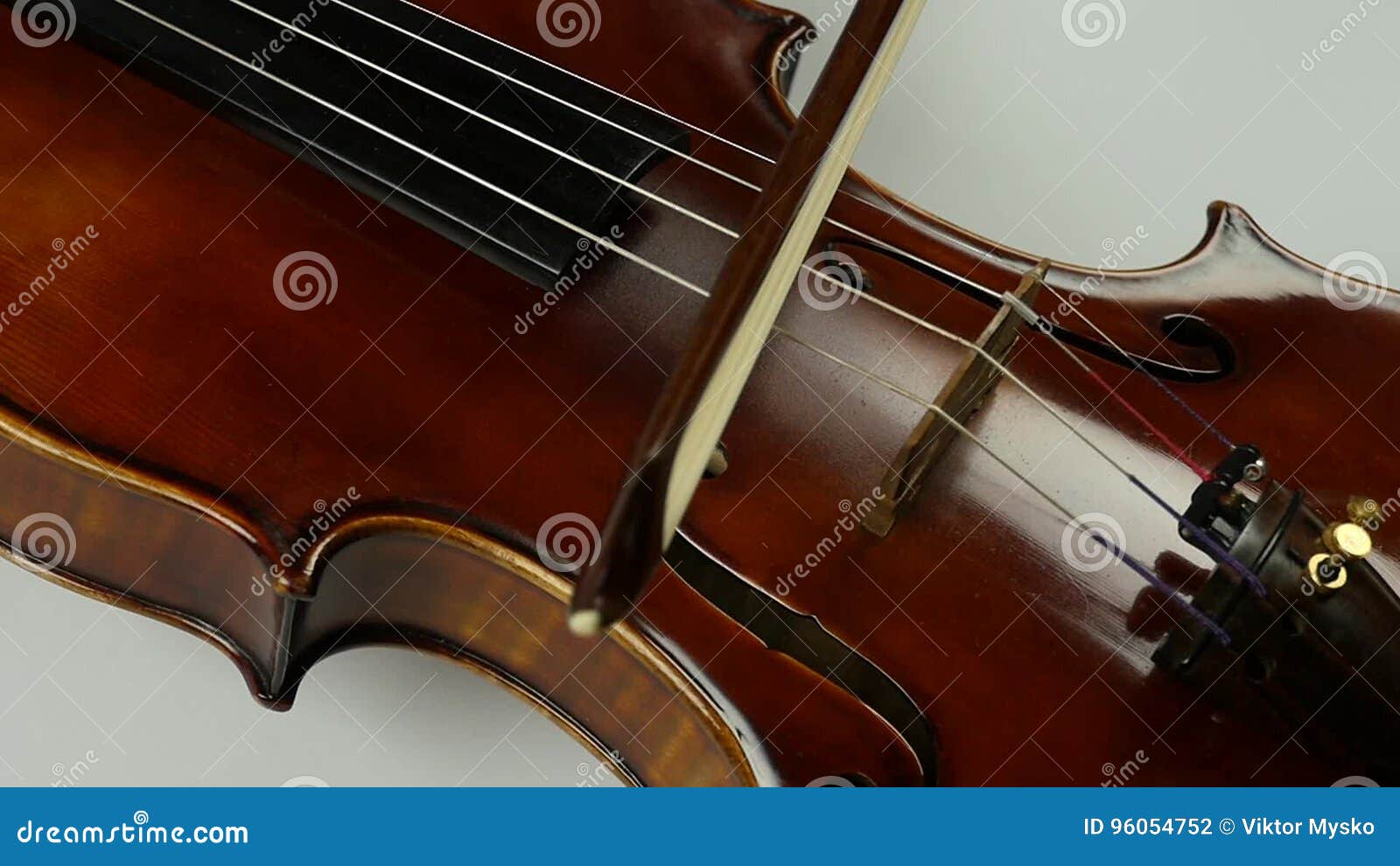 Close Up Soundboard of Violin and Bow. the Bow Moves Along the Violin ...