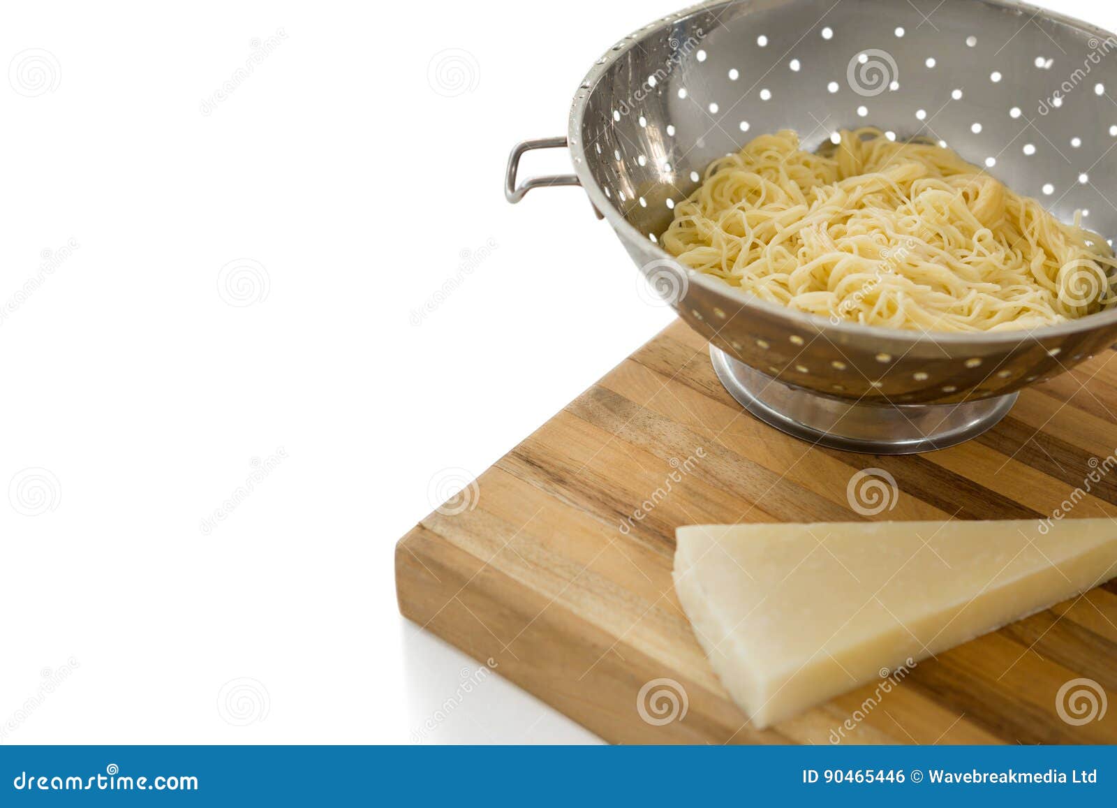 Close Up of Spaghetti in Colander by Cheese on Cutting Board Stock ...