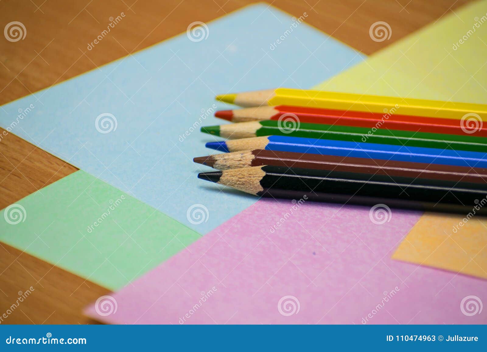 Close Up Stack Colour Pencils on Papper and Wooden Background Stock ...