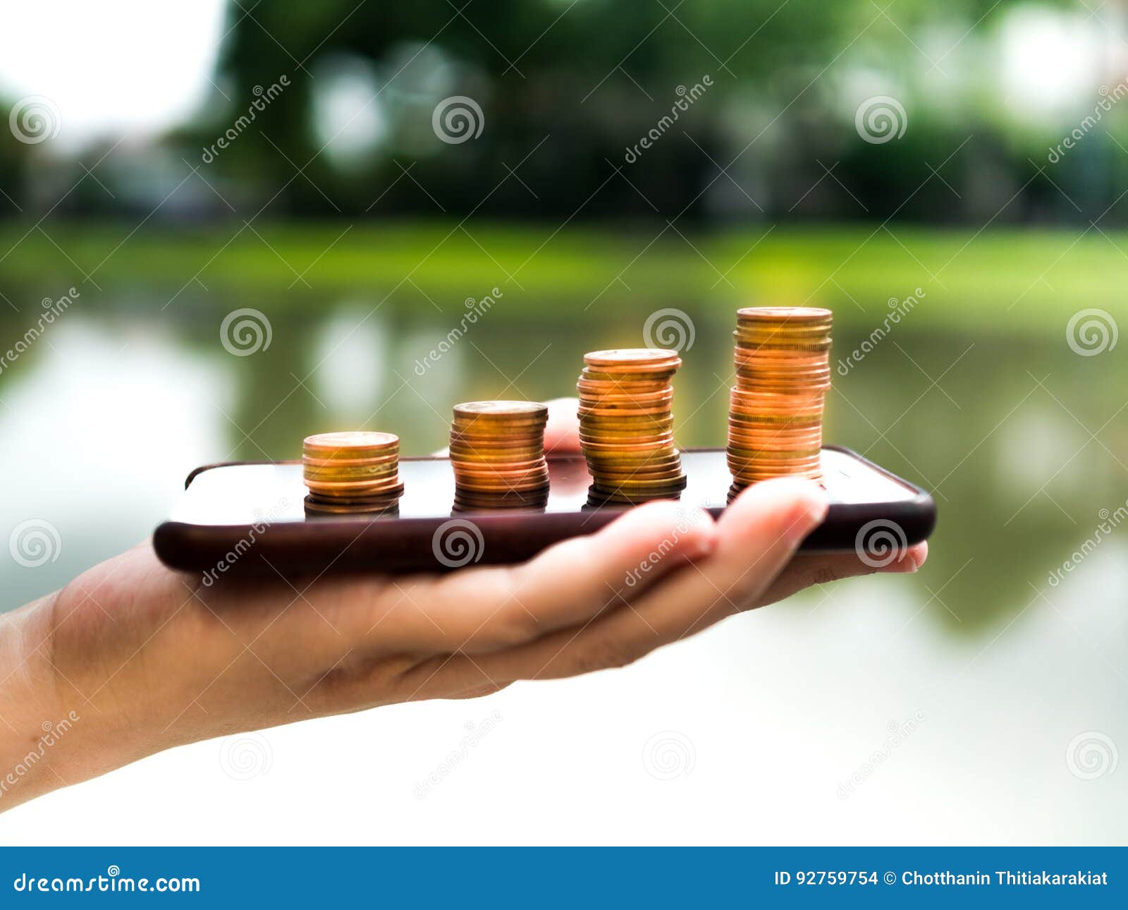 Close Up Stack of Money Coins on the Mobile Phone, Business in ...