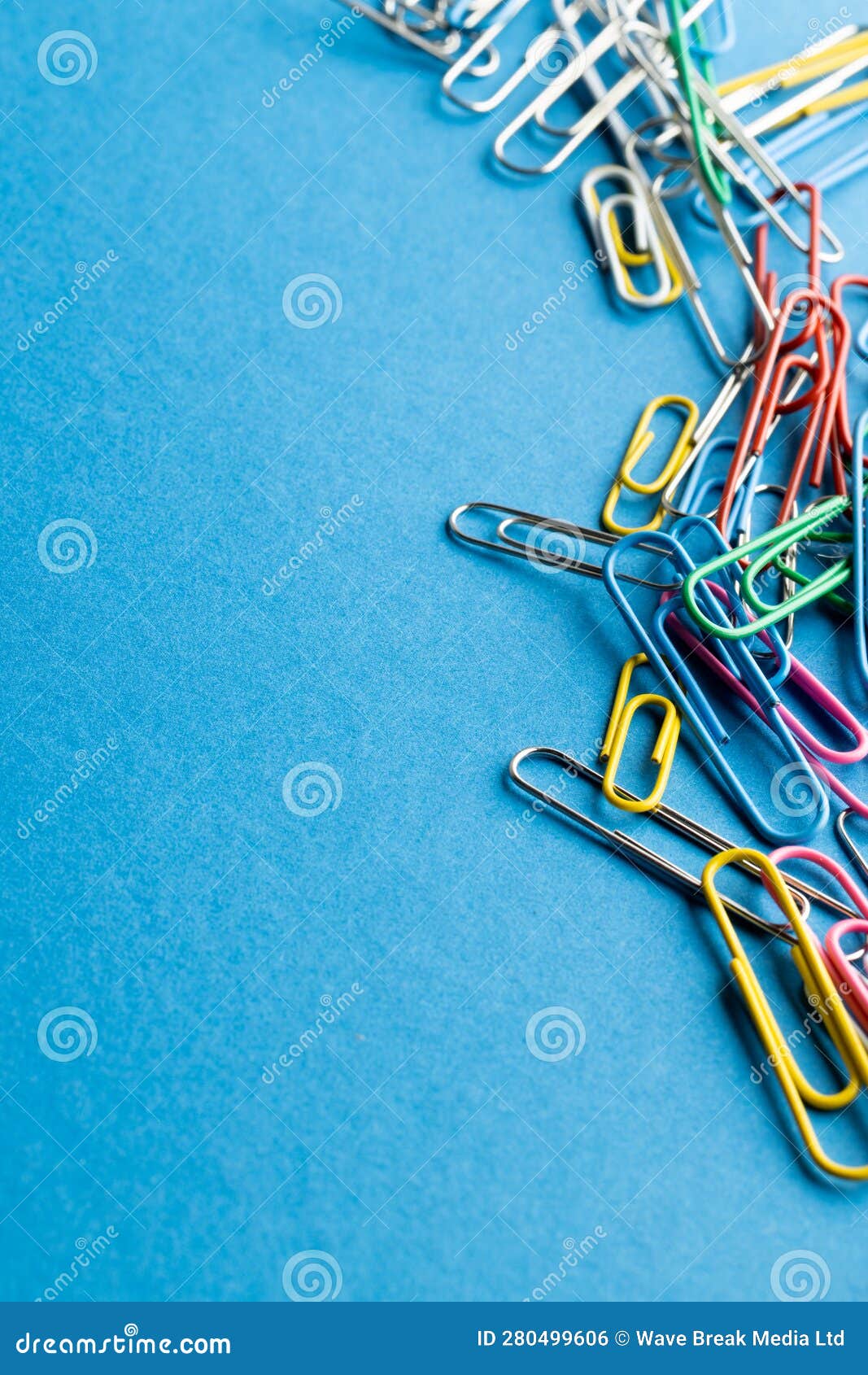 Close Up of Stack of Multi Coloured Paper Clips and Copy Space on Blue ...