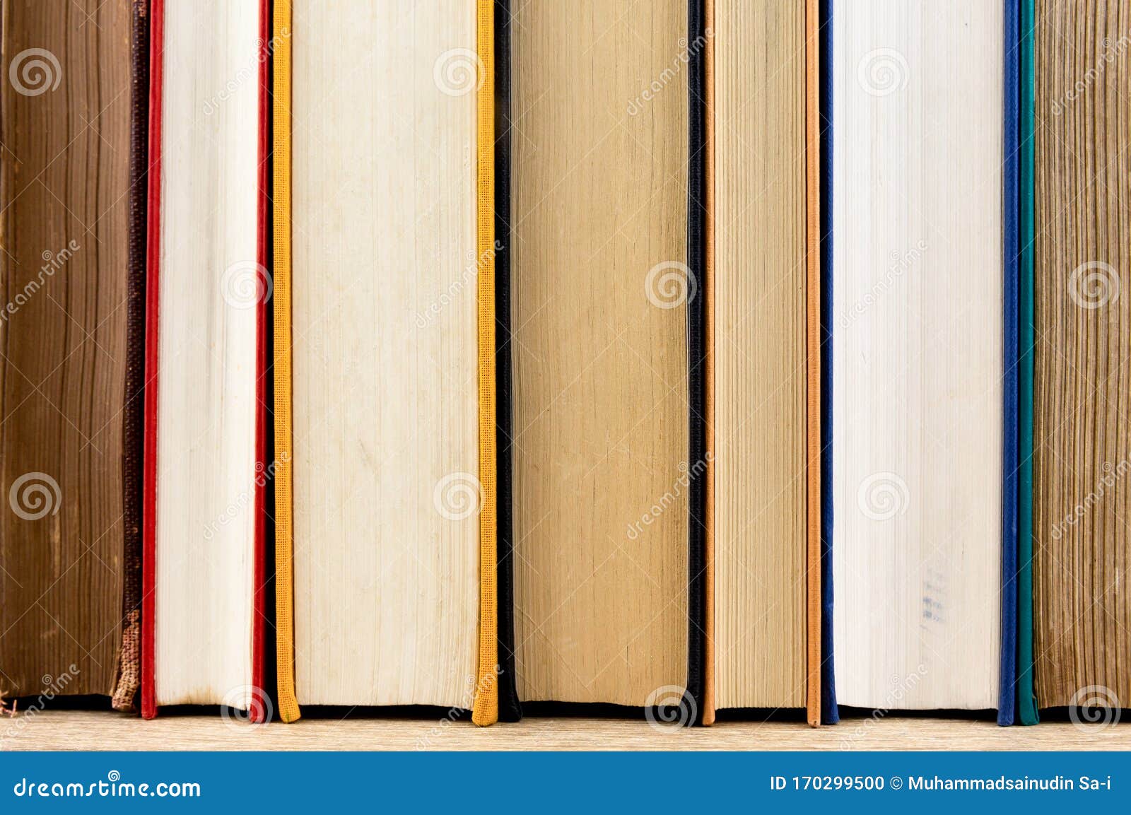 Close Up Stack of Old Books Vertically Placed on the Wooden Shelf Stock ...