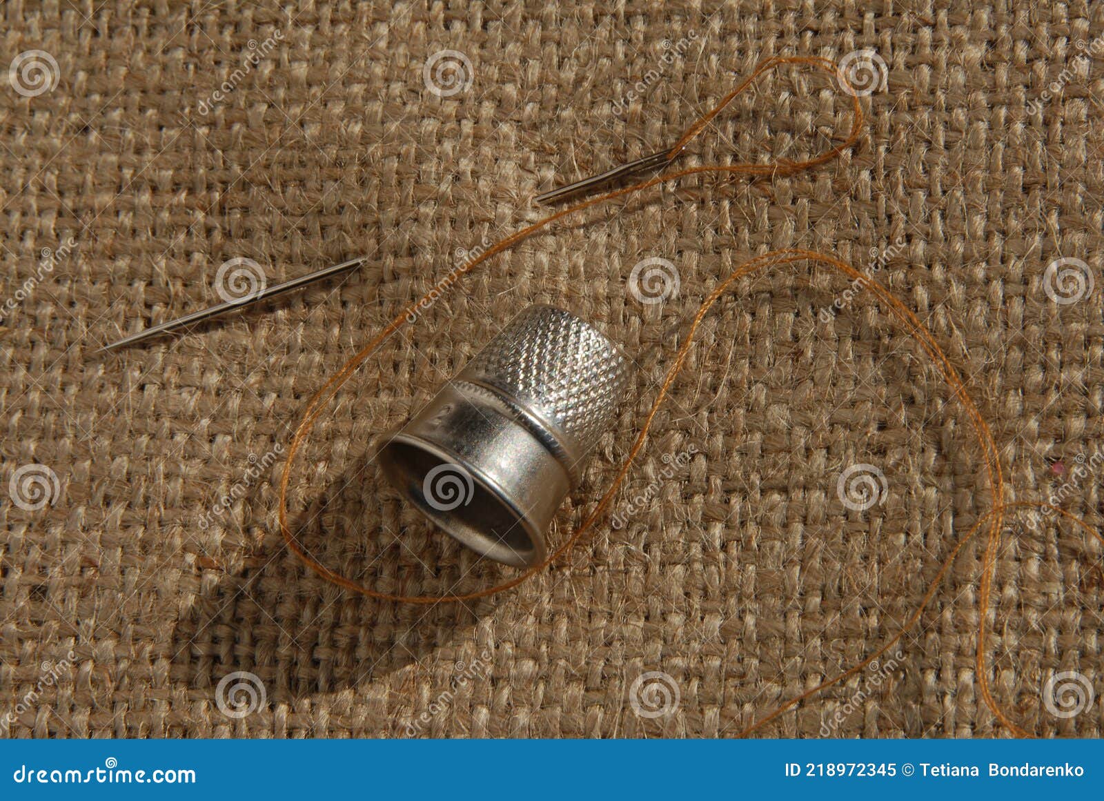 Close-up of Steel Thimble and Needle and Thread on a Background of ...