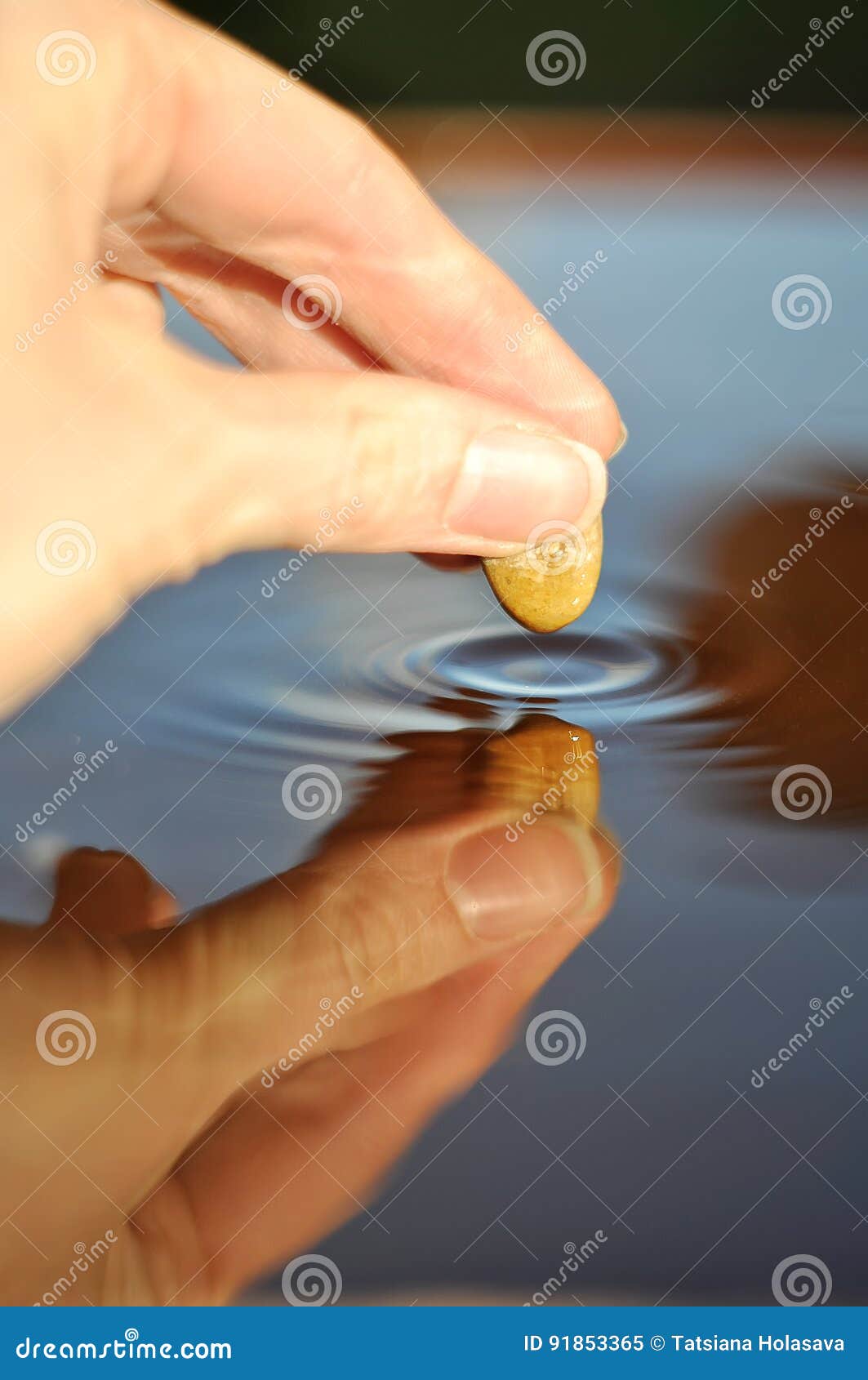 Close-up of Stone Touching Water Surface, Creating Ripple. Stock Image ...