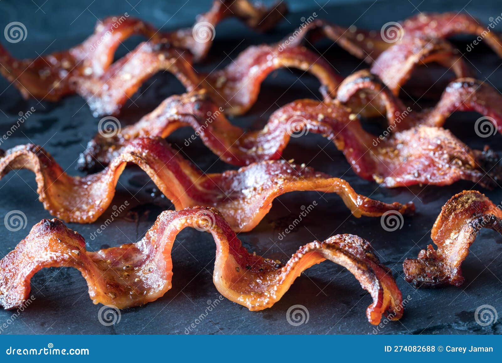 Strips of Crispy Maple Pepper Bacon on a Black Slate Board. Stock Photo ...