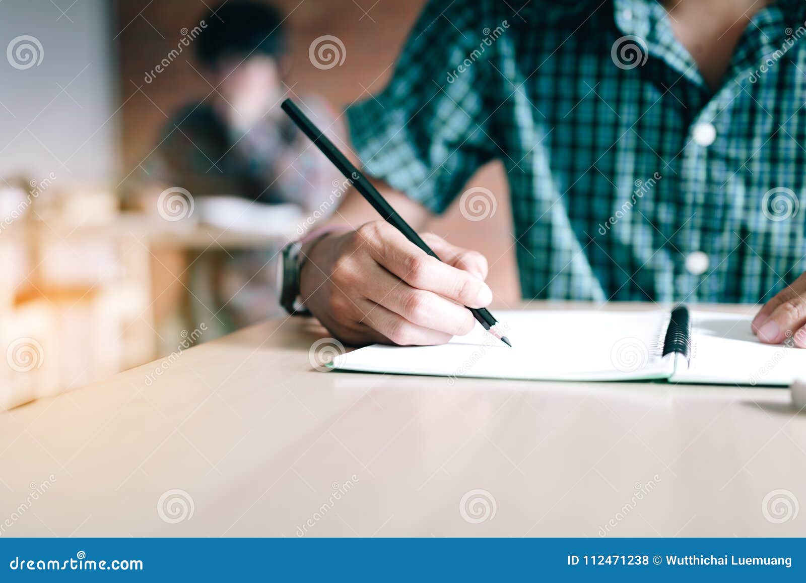 Close Up of Student Hand Writing on Paper with a Pencil in Class Stock ...