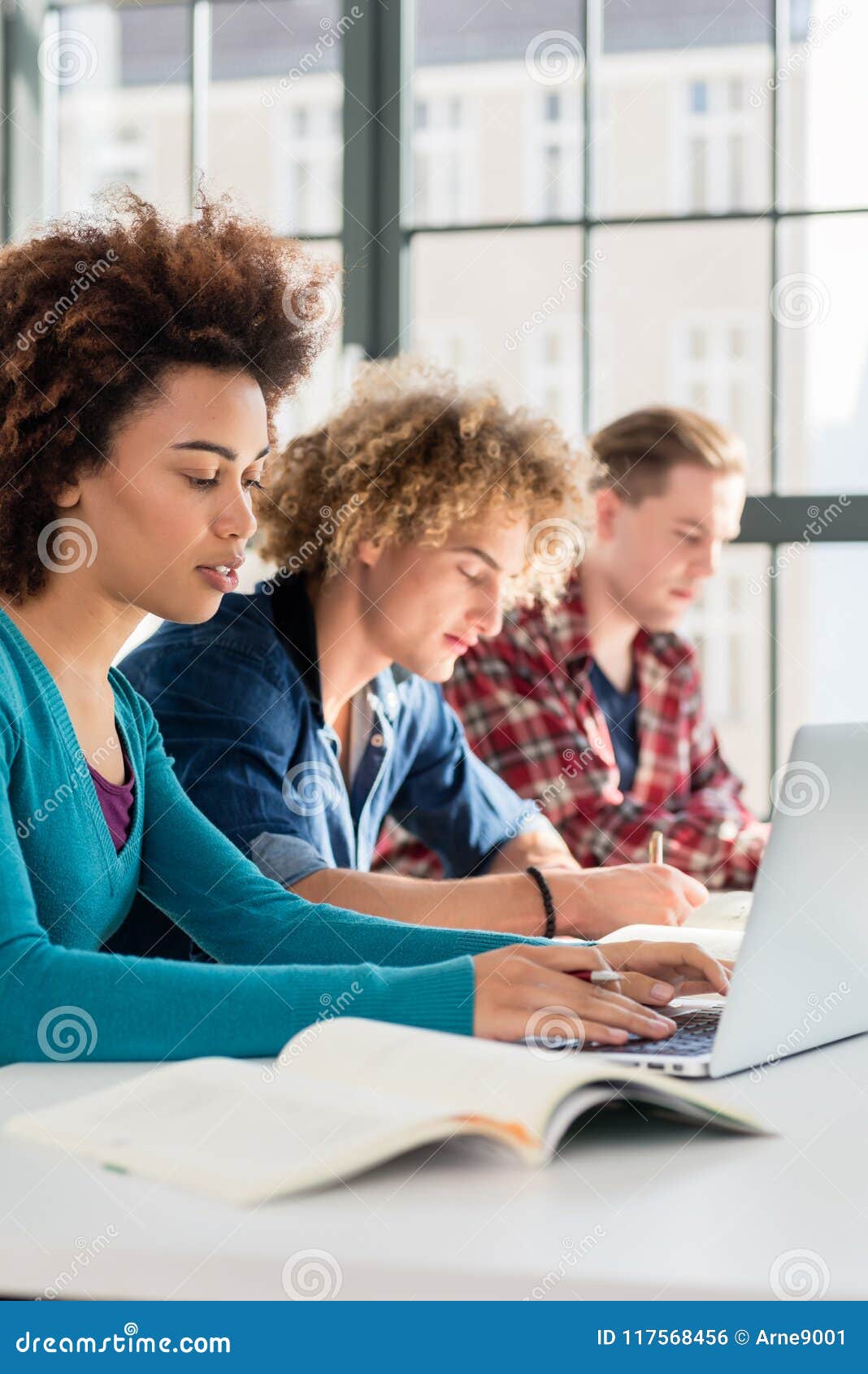 Close-up on Student Holding a Pen Over a Book while Studying a Text ...