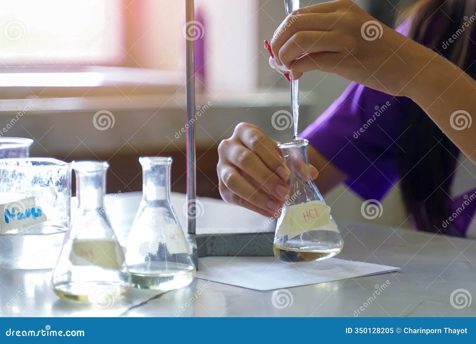 Close-up of a Student Performing an Acid-base Titration Experiment ...