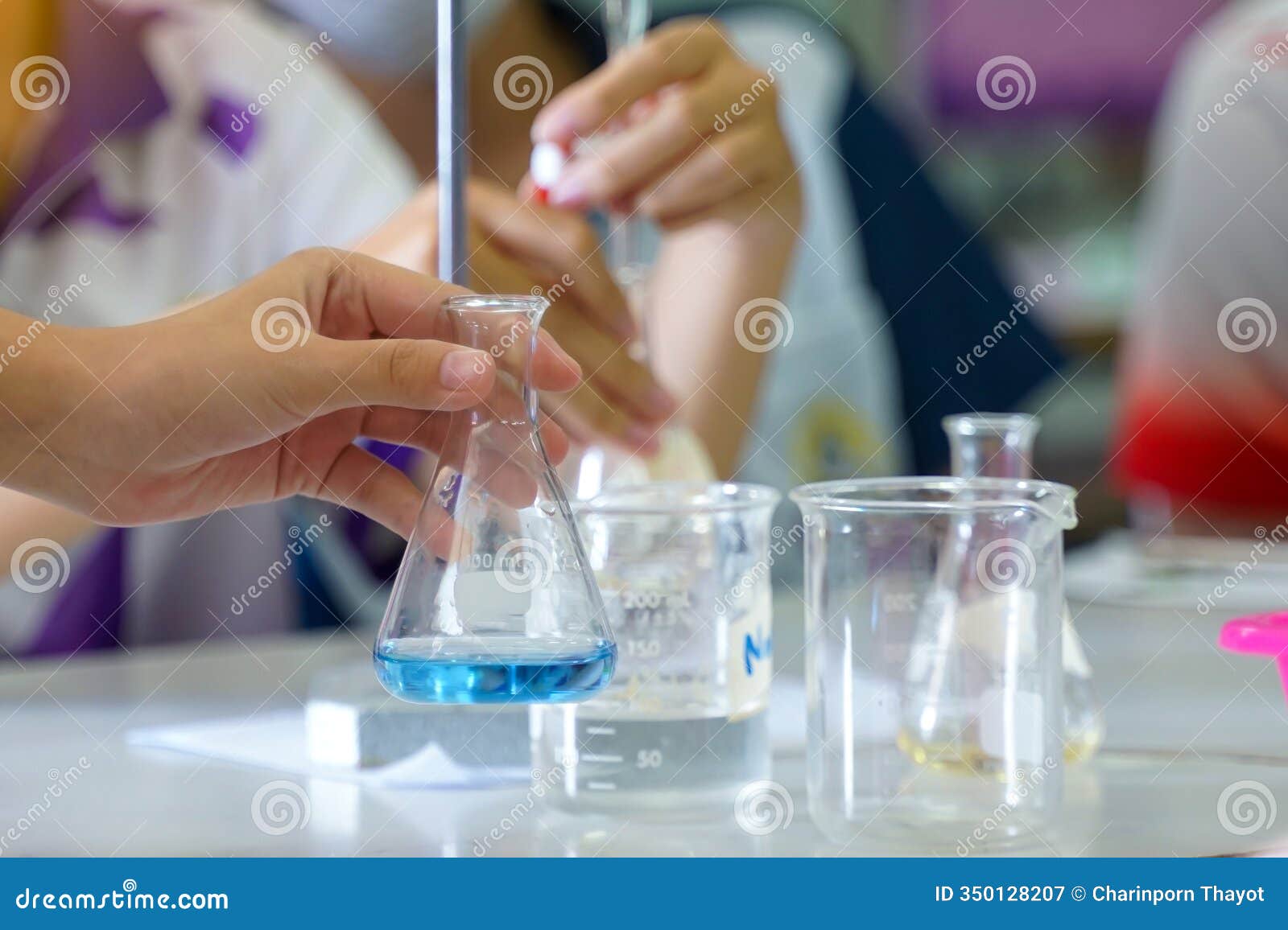 Close-up of a Student Performing an Acid-base Titration Experiment ...