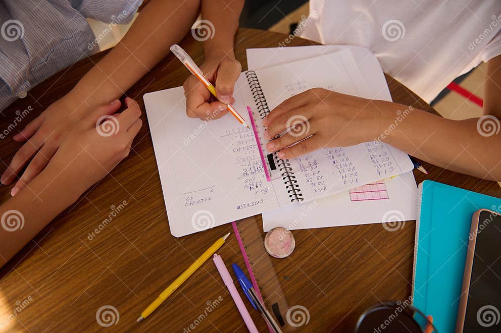 Students Collaborate on Math Homework at Wooden Desk Stock Photo ...