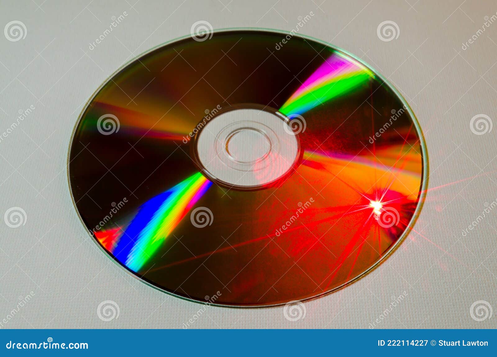 A Studio Photograph of a Compact Disc with a Laser Shining on the ...