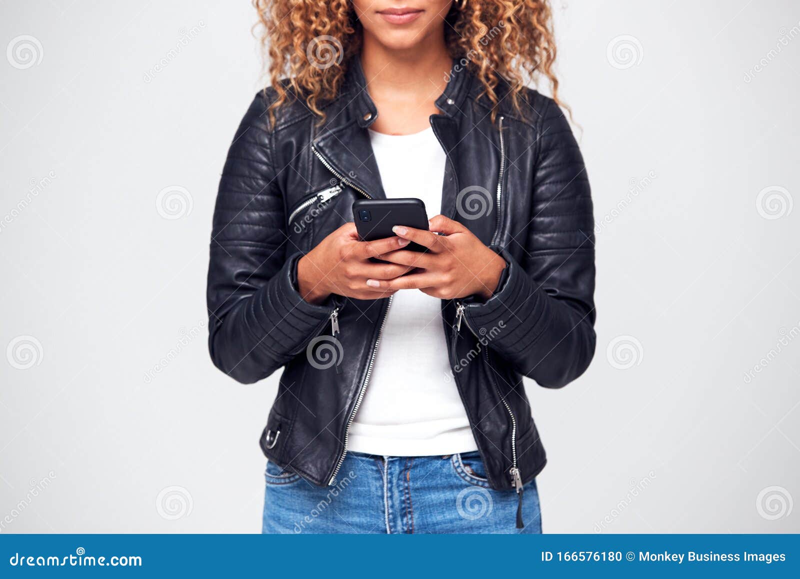 Close Up Studio Shot of Woman Wearing Leather Jacket Using Mobile Phone ...