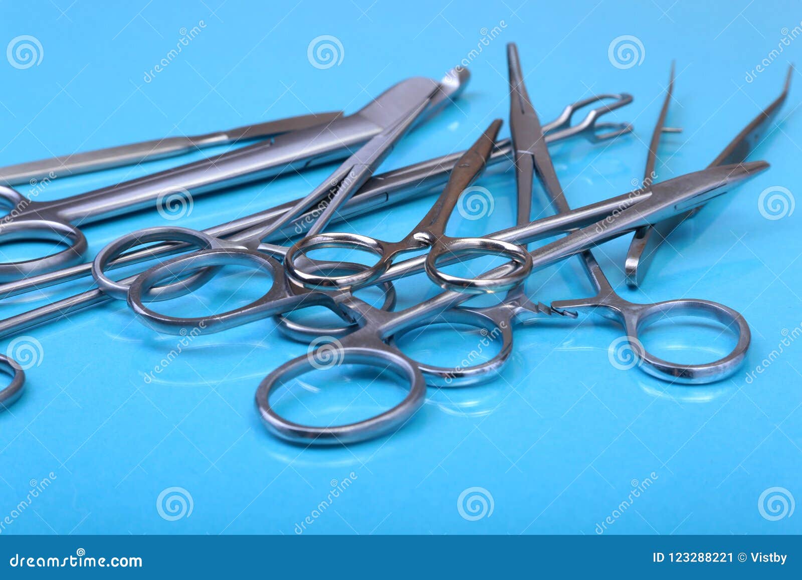 Close Up Surgical Instruments and Tools on Blue Mirror Background ...