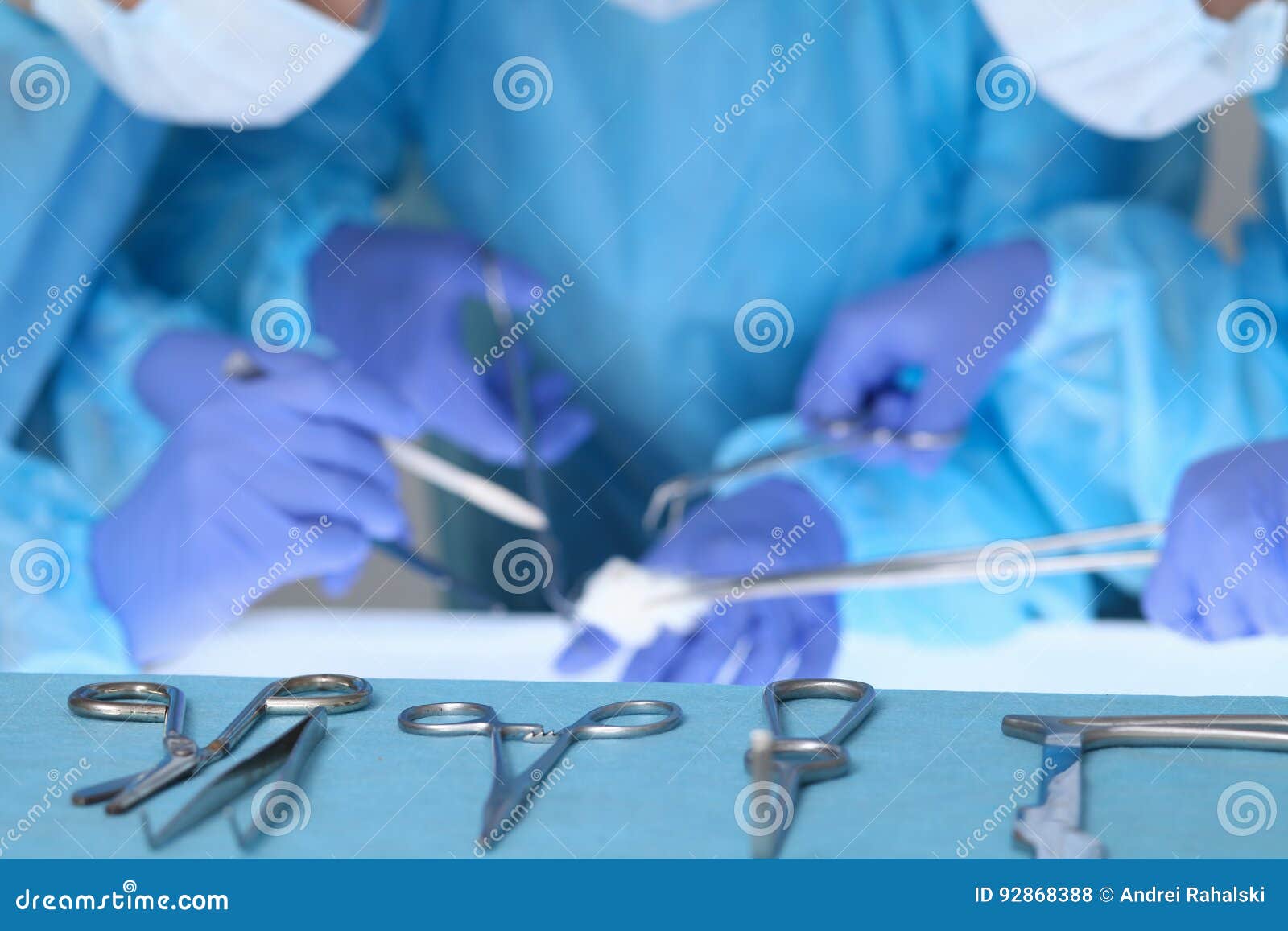 Close Up of Surgical Tools while Group of Surgeons at Work in Operating ...