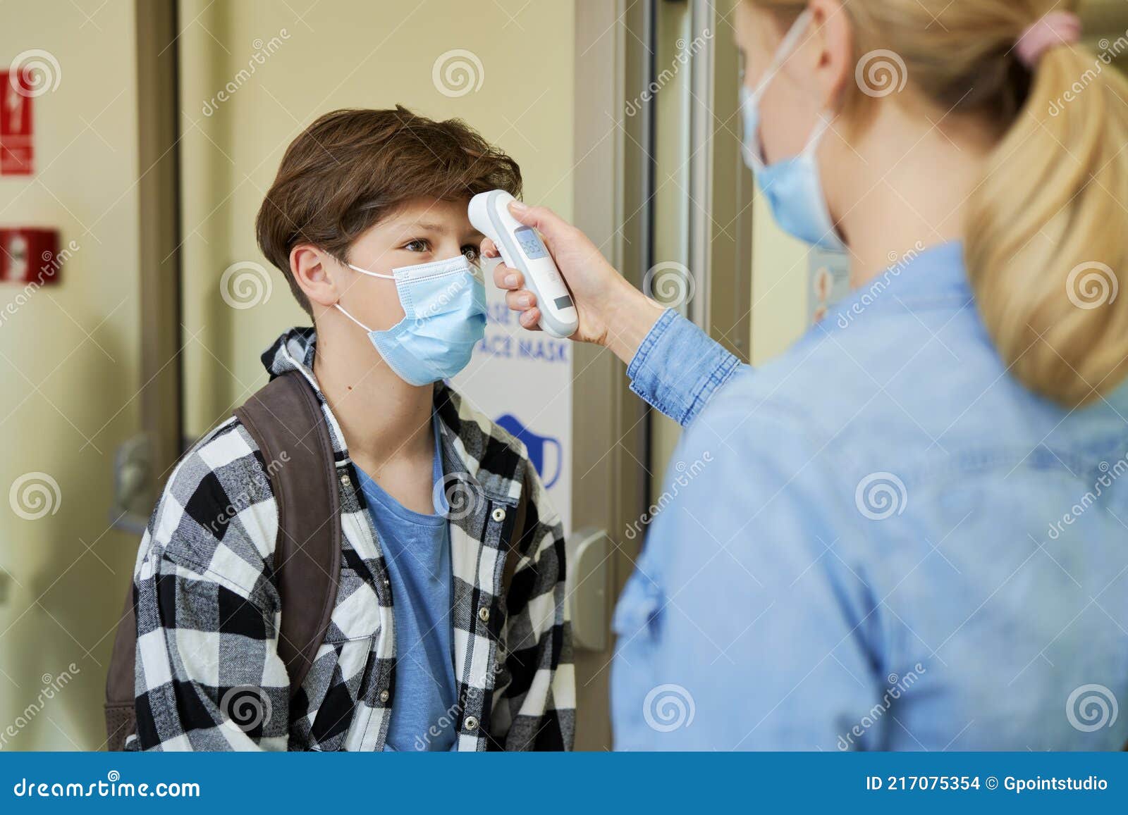 Teacher Checking the Temperature of the Students before Entering the ...