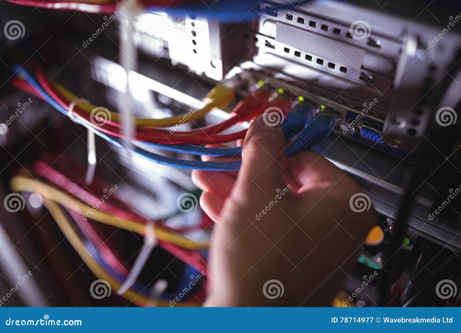 Close-Up of Technician Plugging Patch Cable in a Rack Mounted Server ...