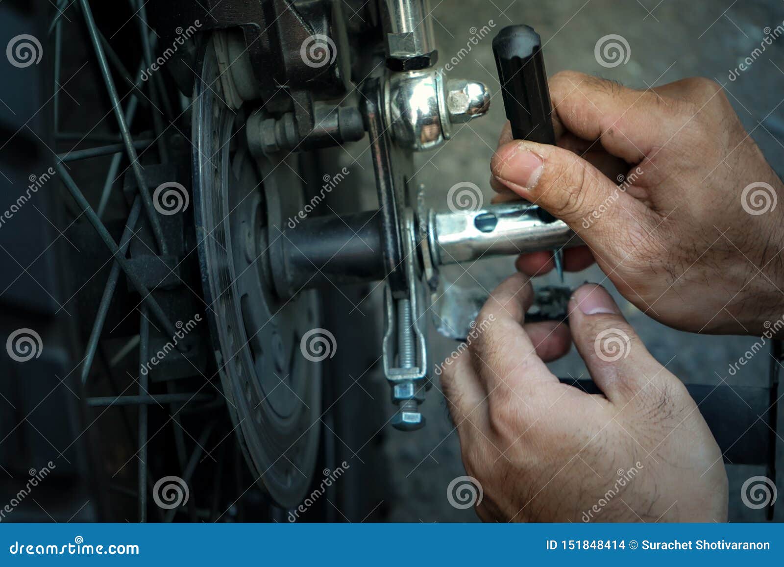 Close Up Technician Worker Hand, Fixed Motocycle Wheel at the Outside ... Close Up Technician Worker Hand, Fixed Motocycle Wheel at the Outside ...
