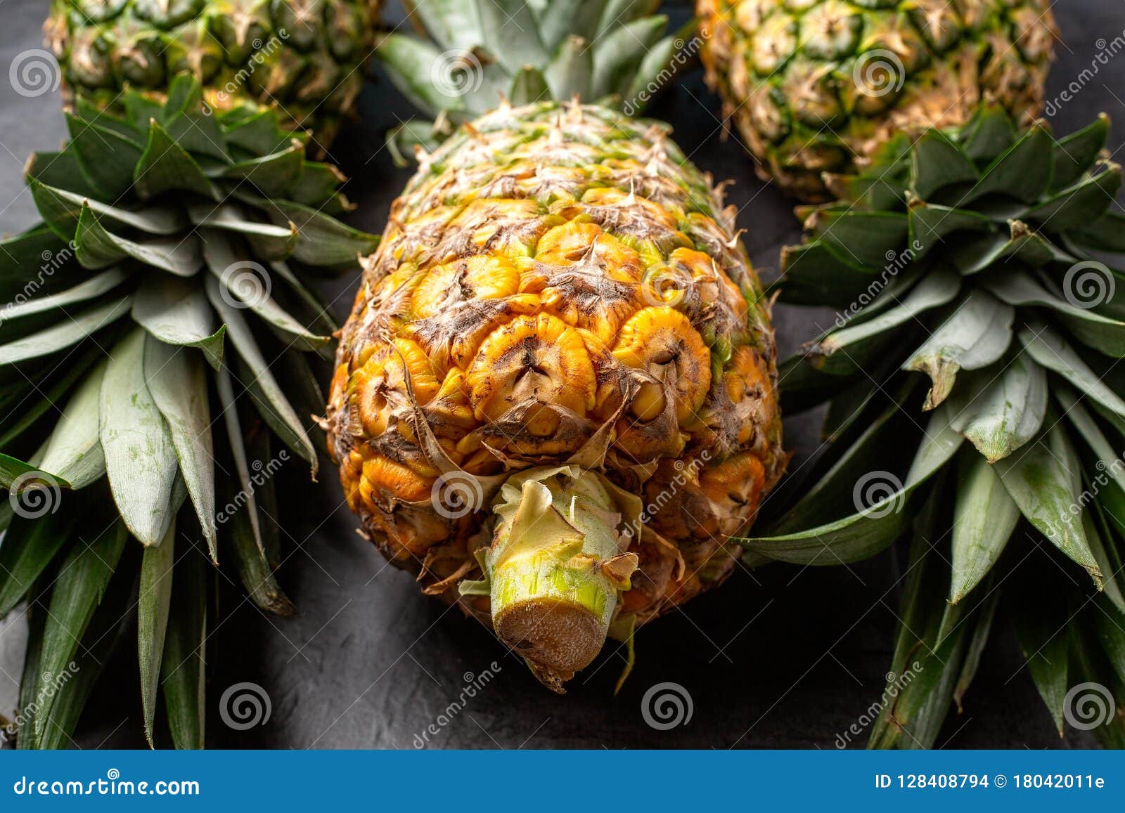 Close Up Of Three Ripe Fresh Pineapples On Dark Background Stock Photo ...