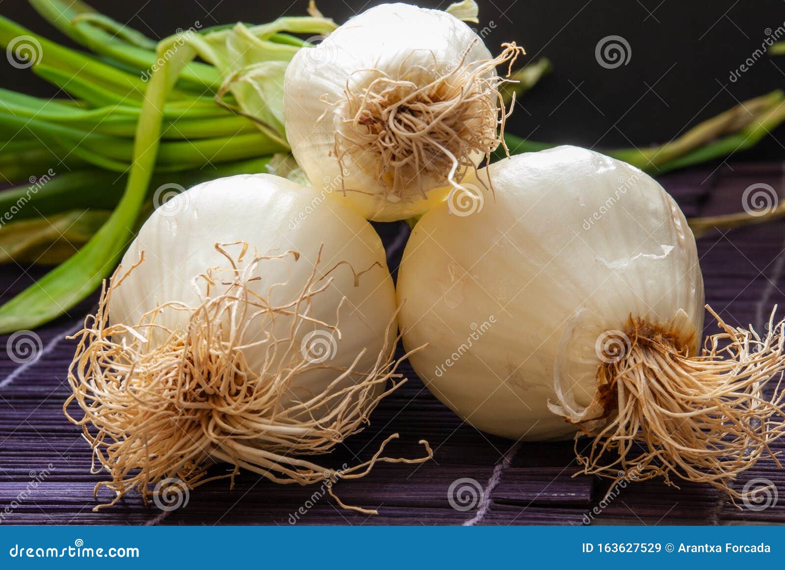 Close-up of Three Scallions on Purple Mat with Dark Horizontal Stock ...