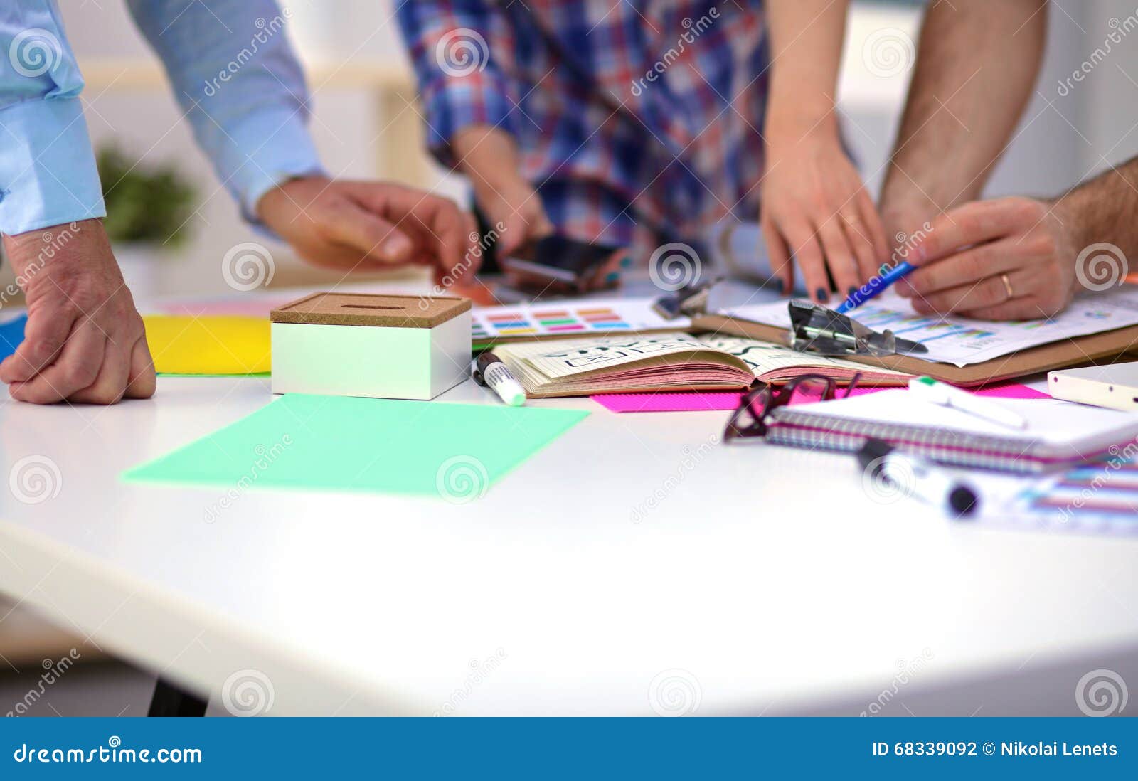 Close-up of Three Young Creative Designers Working on Project Together ...