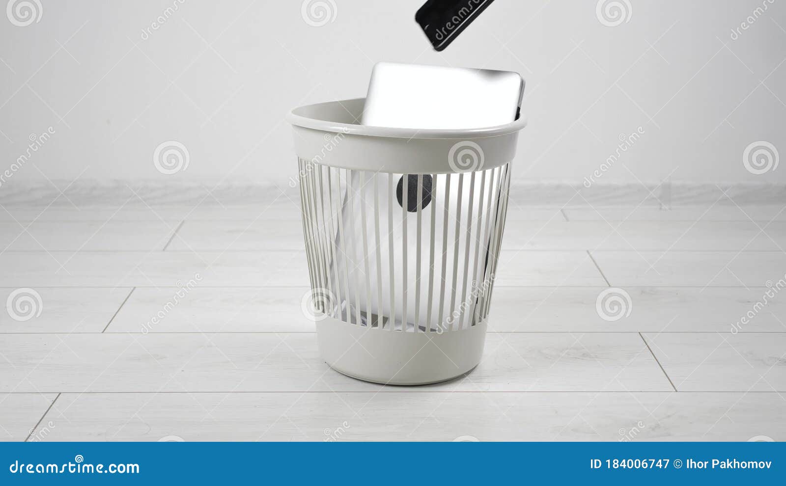 Close-up Throwing Laptop Computer and Smartphone To the Trash Bin. the ...