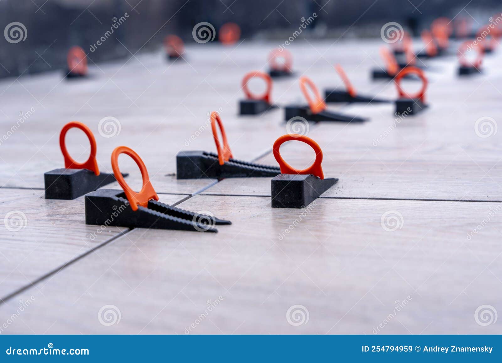 Close-up of the Tile Alignment System Holding Tile in Given Position ...